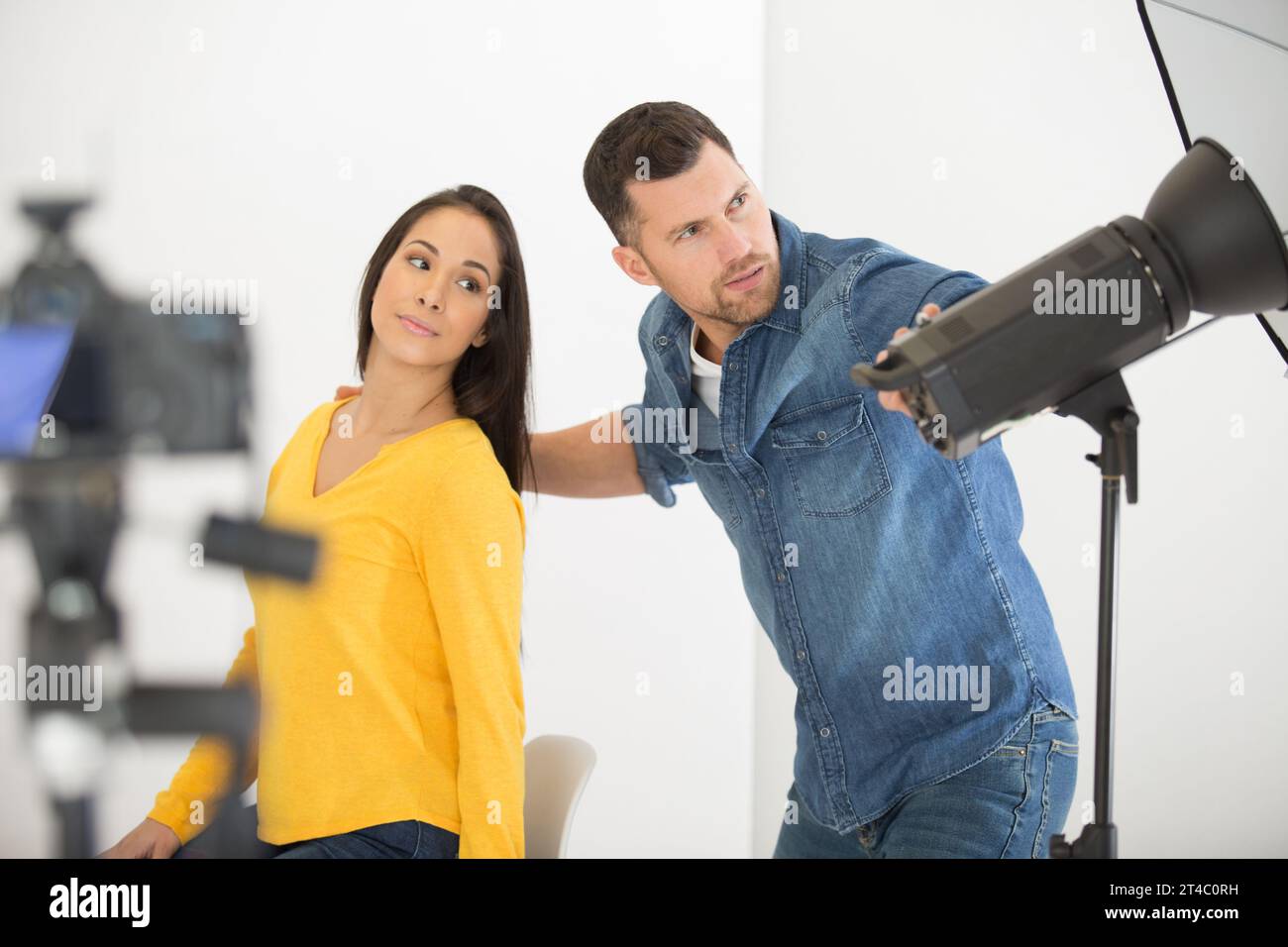 photographer positioning model during studio shoot Stock Photo - Alamy