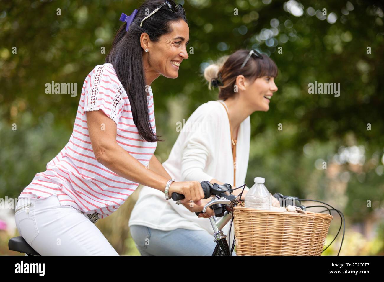 two friends on bikes outdoors smiling Stock Photo - Alamy
