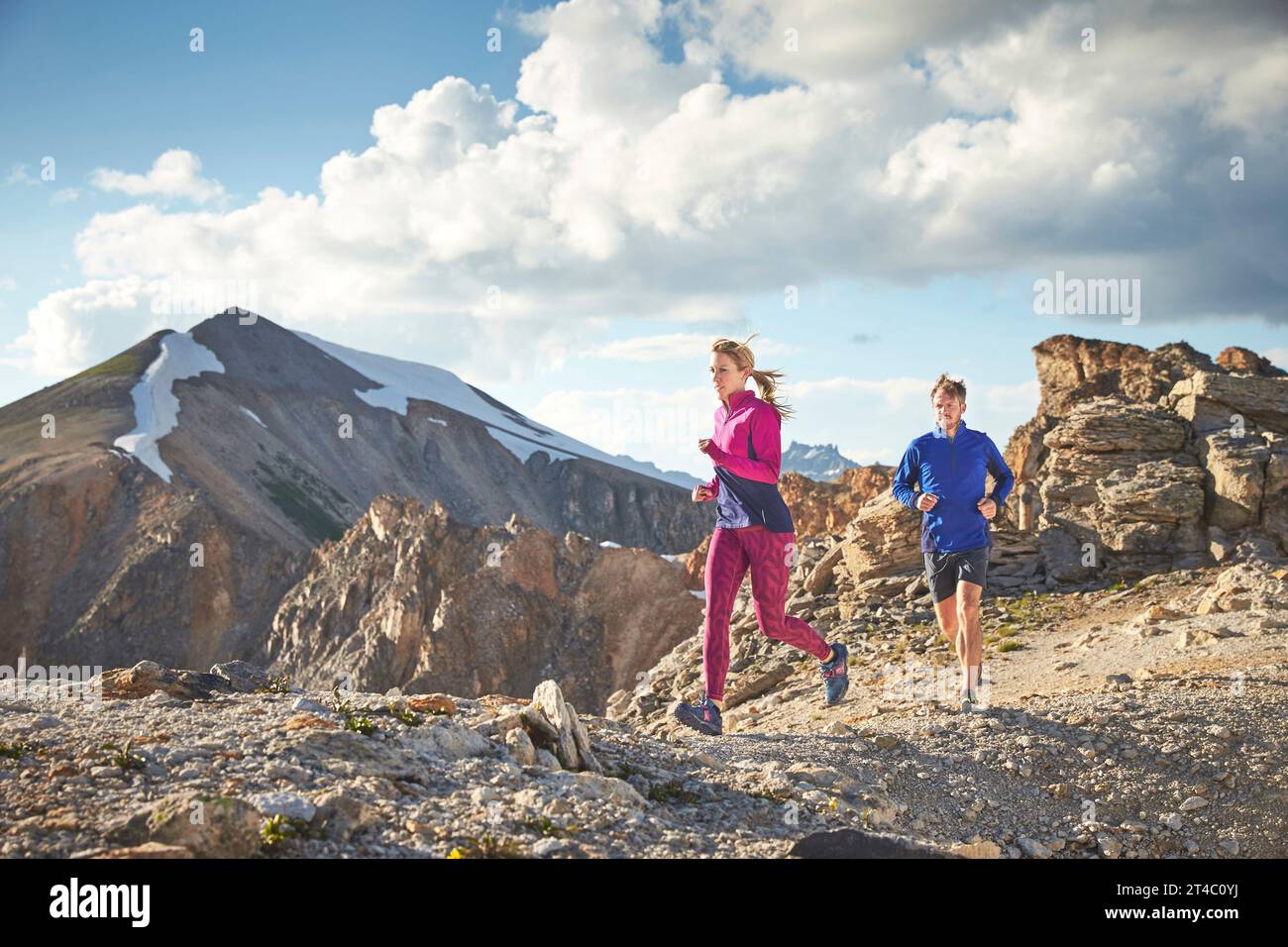 man and women trail run in the San Juan Mountains high above Telluride ...