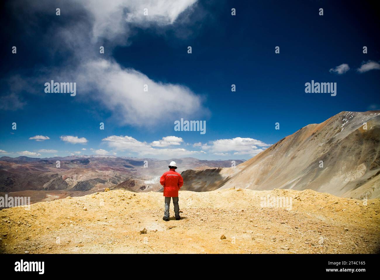 Pascua Lama mine, Chile. A worker stands on the crest of the Andes ...