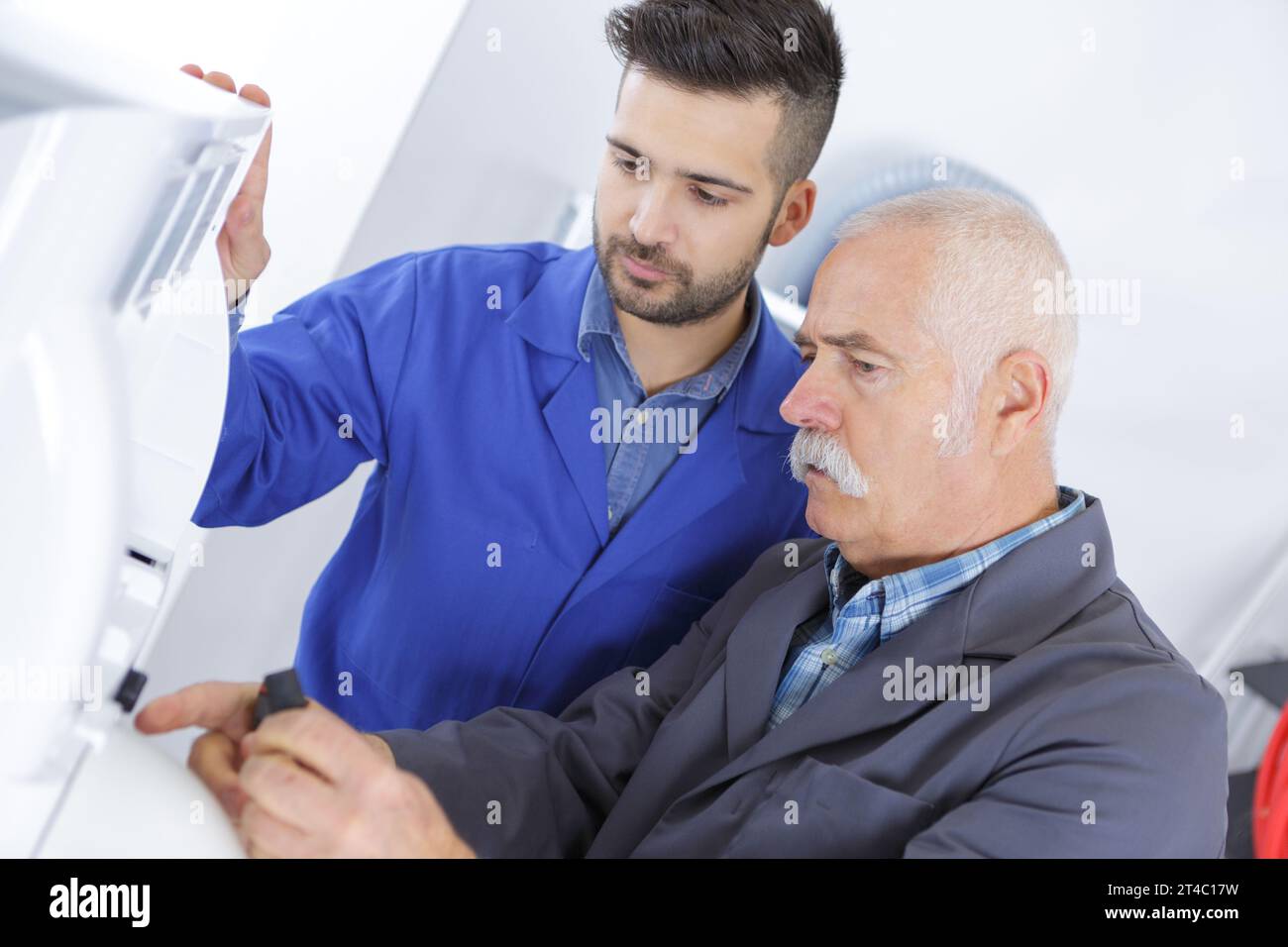 Workers heavy machinery fix broken hi-res stock photography and images ...