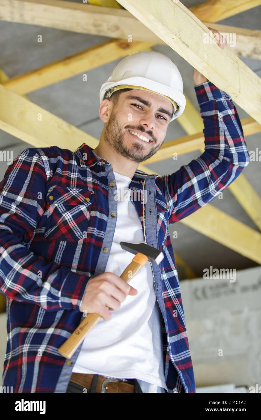 happy male carpenter with hammer Stock Photo - Alamy