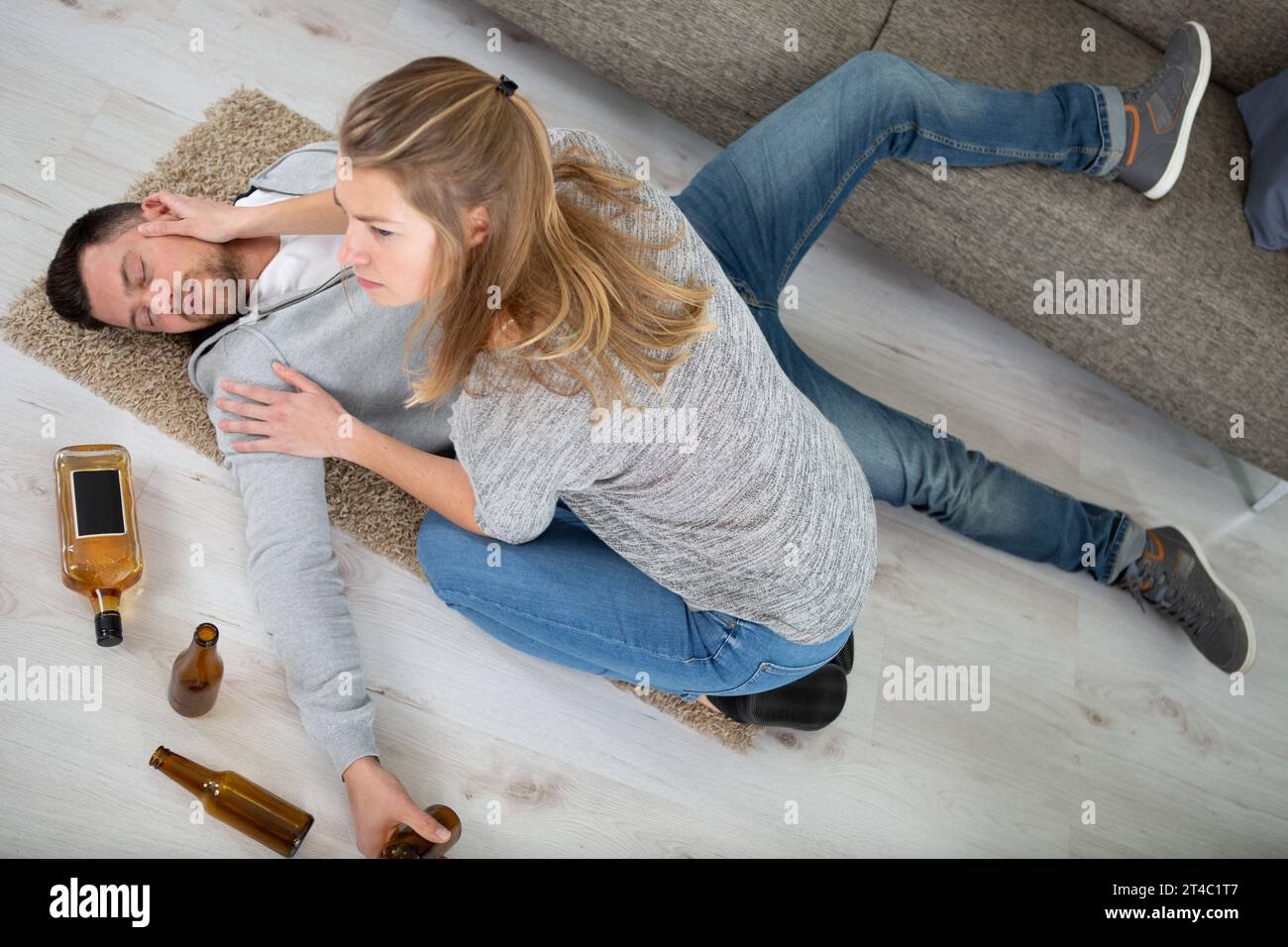 girlfriend trying to wake drunk boyfriend up Stock Photo - Alamy