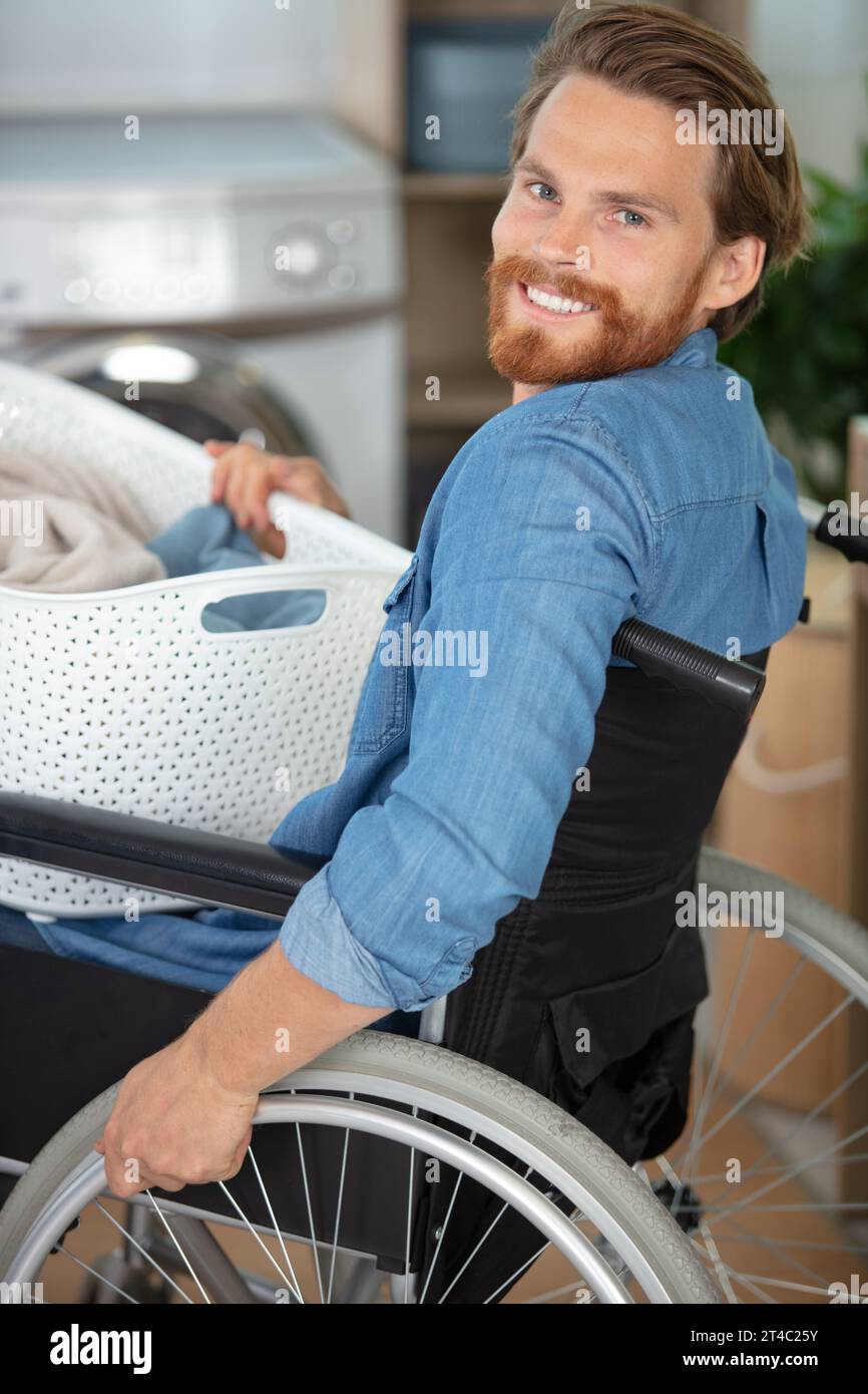 disabled man in wheelchair doing laundry Stock Photo - Alamy