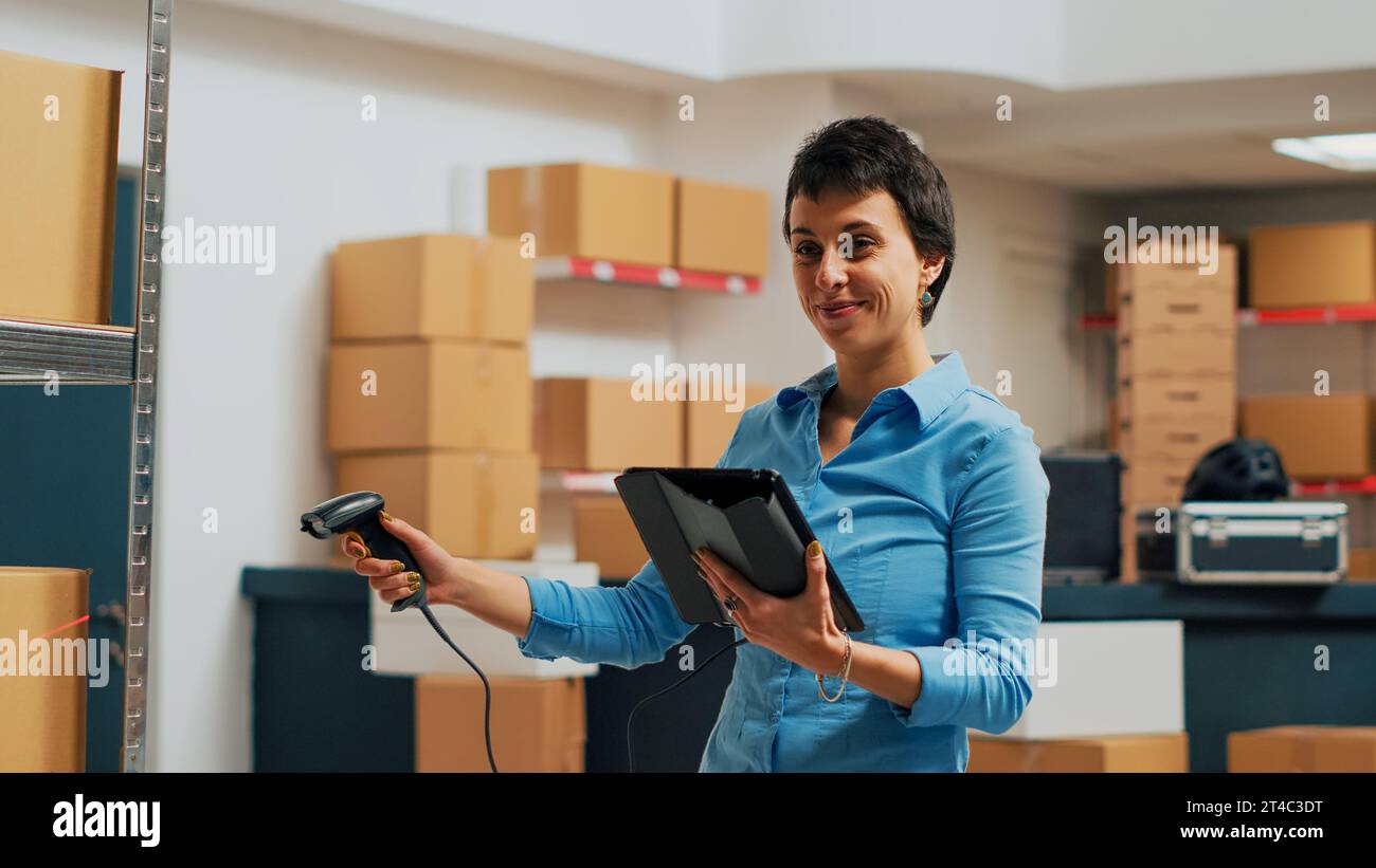 Young employee scanning products from warehouse, working with scanner ...