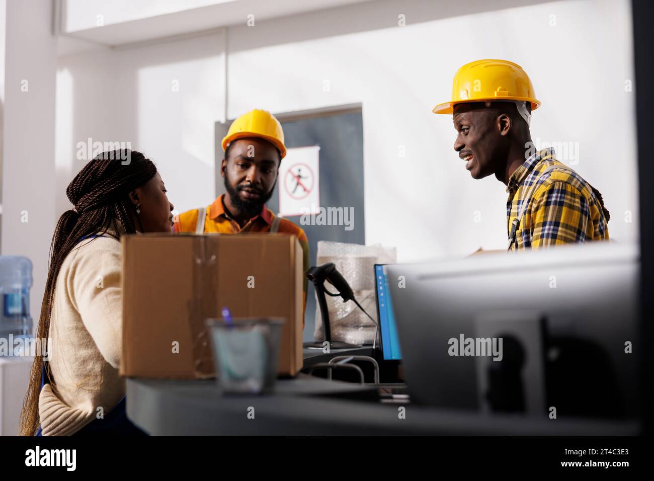 Delivery service employees discussing packages storing at warehouse ...