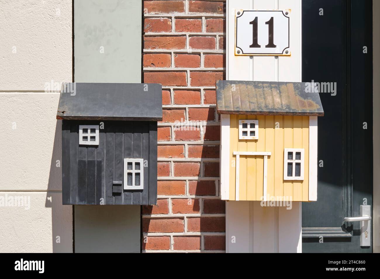 Two mailboxes in the shape of a house on the facade of a building Stock ...