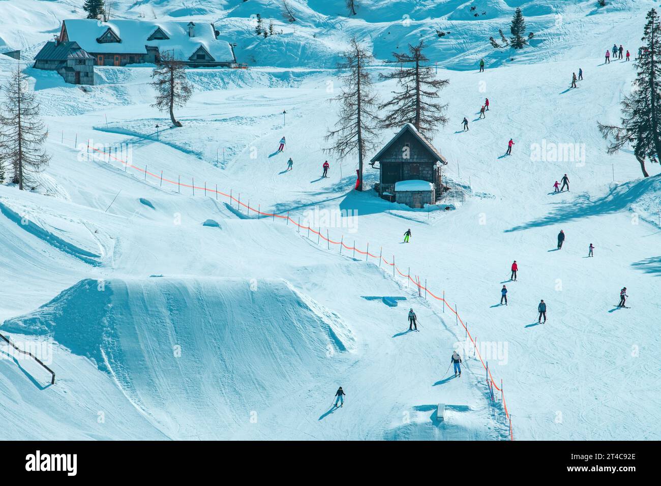 Large group of skiers enjoying sunny winter day on ski slope ...