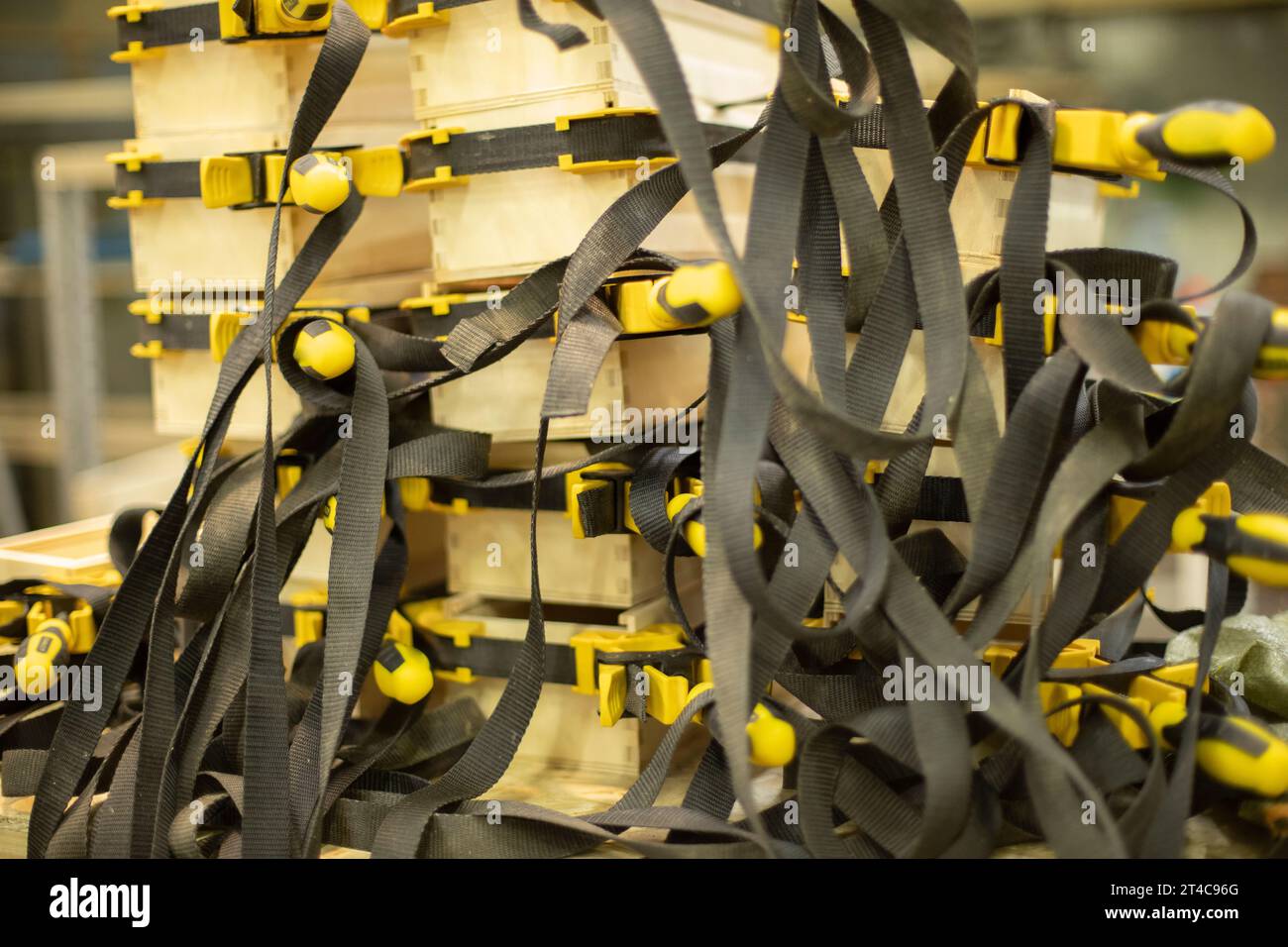 Tightening boards. Tool for fixing parts. Straps are black. Wooden boxes are glued together ...
