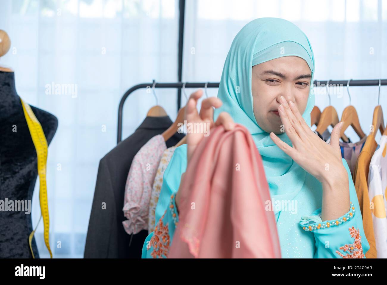 Portrait housewife Asian woman is smelly stinky musty from clothes ...