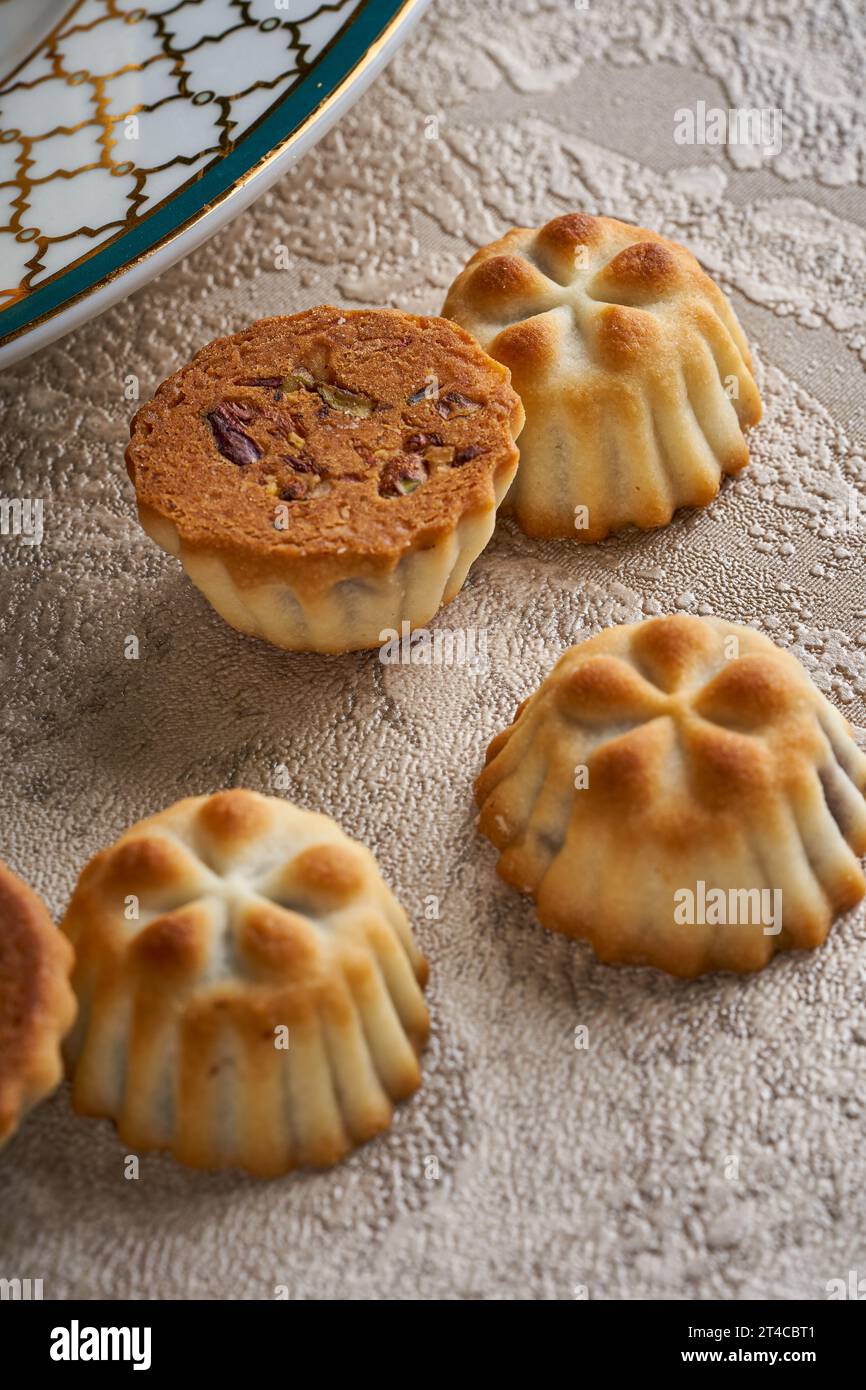 A close-up photo of pieces of Syrian Eid sweets (maamoul) stuffed with ...