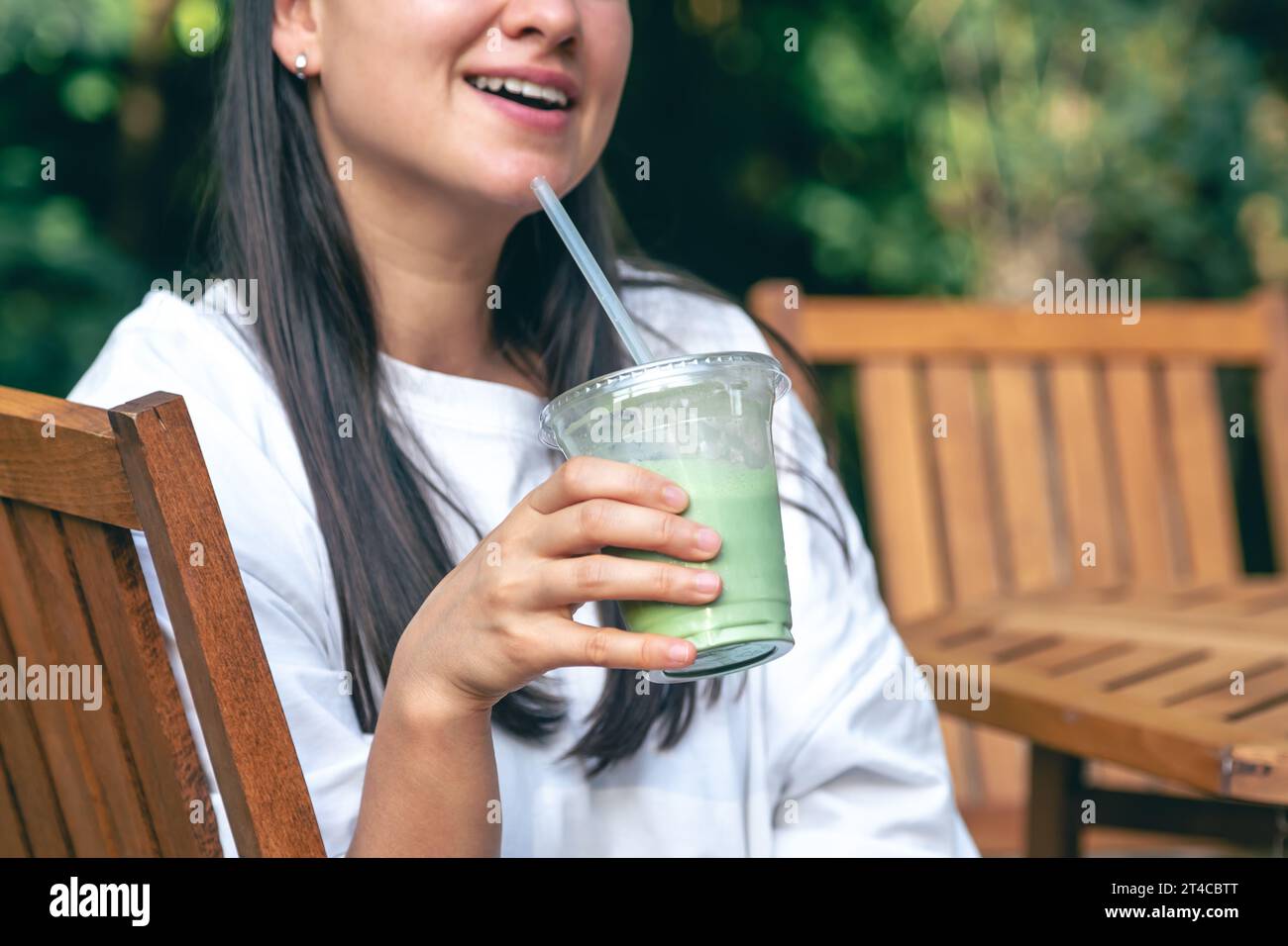 Woman drinking matcha latte, healthy iced drink Stock Photo - Alamy