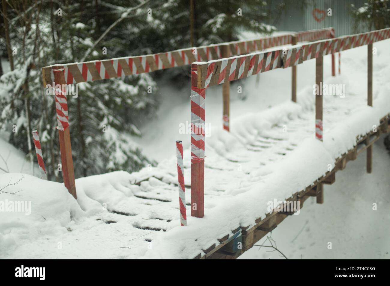 Bridge over the ravine in winter. Wooden bridge in the woods. Crossing ...