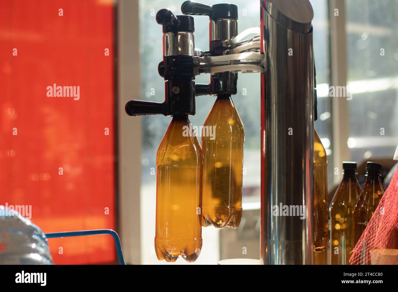 Drinks on tap. Alcol machine for filling in plastic bottles. Beer is ...