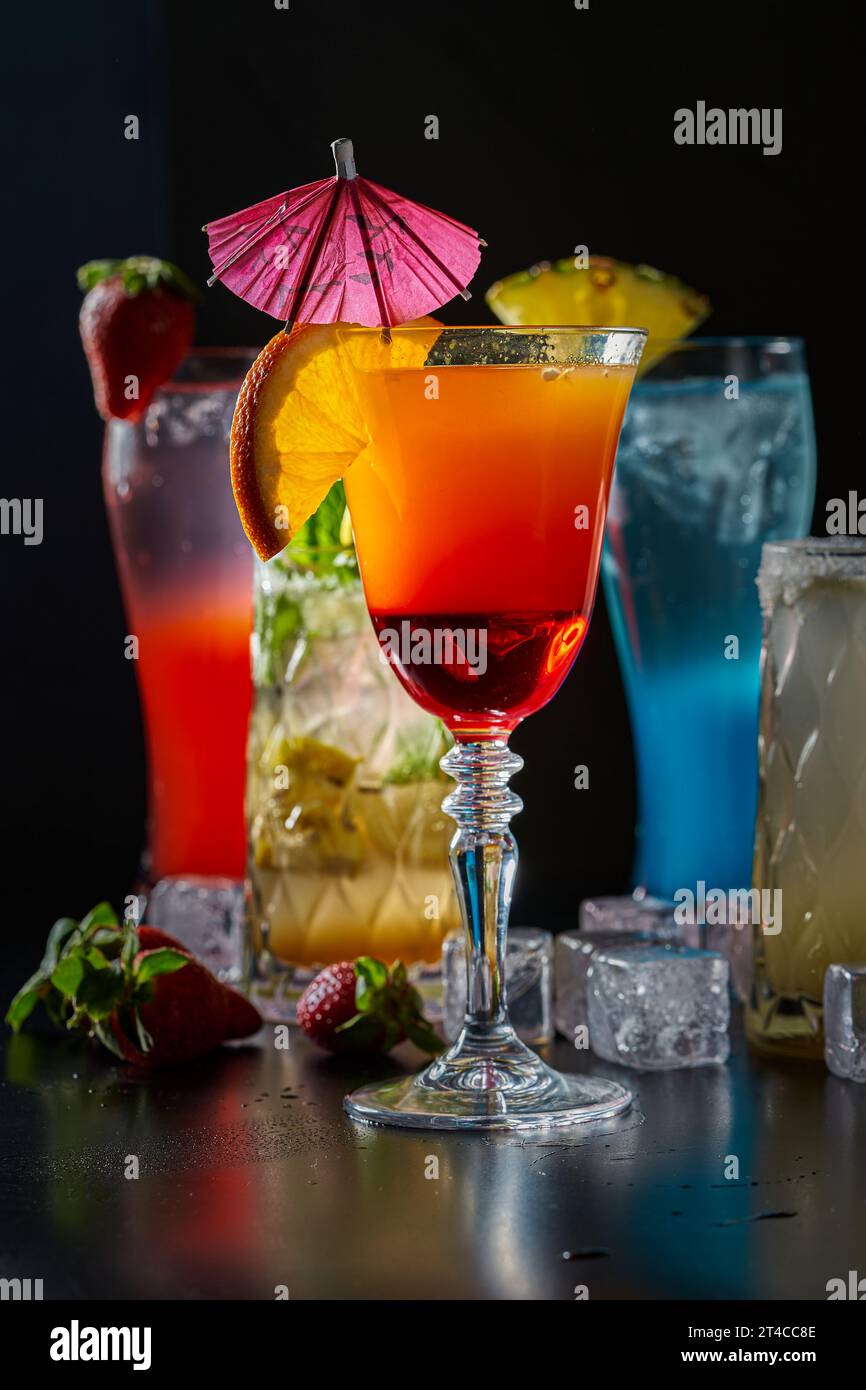 a group of various drinking glasses without alcohol On a black ...