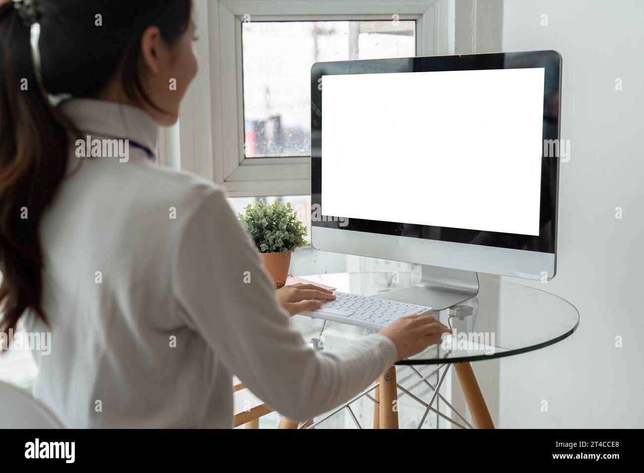 Woman working near window in modern office, blank screen Stock Photo ...