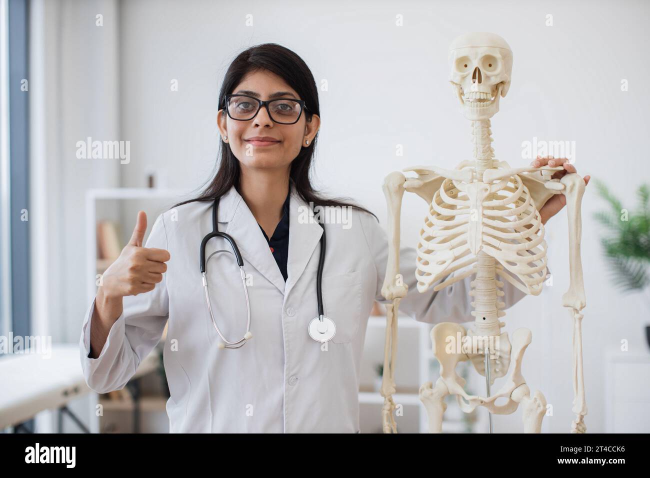 Doctor standing near model of human body in private clinic Stock Photo ...