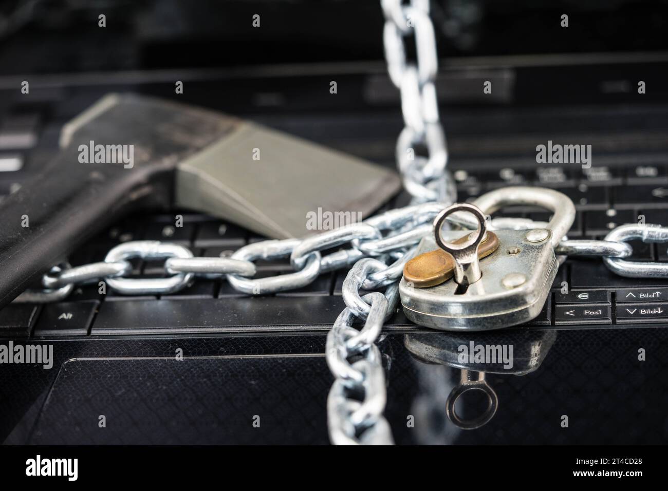 laptop keyboard with chain, safety lock and Ax, data safety Stock Photo ...