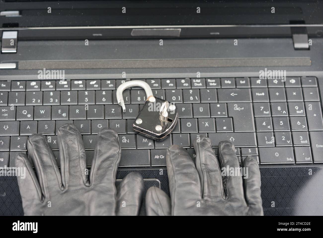 hands with gloves typing on laptop keyboard with safety lock, privacy ...