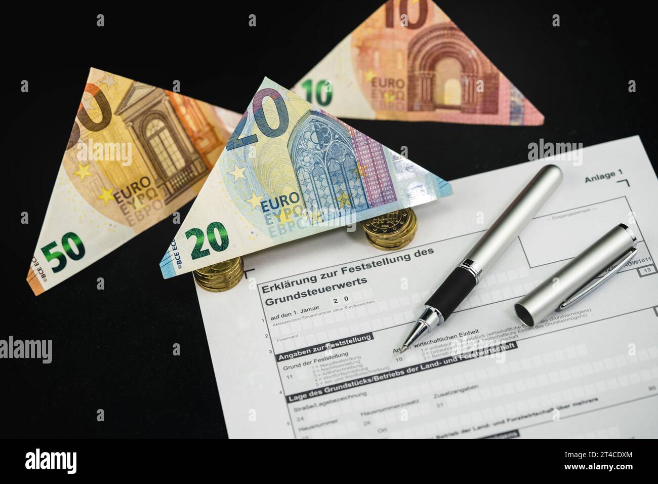 document about land tax with folded Euro bills and ballpen Stock Photo ...