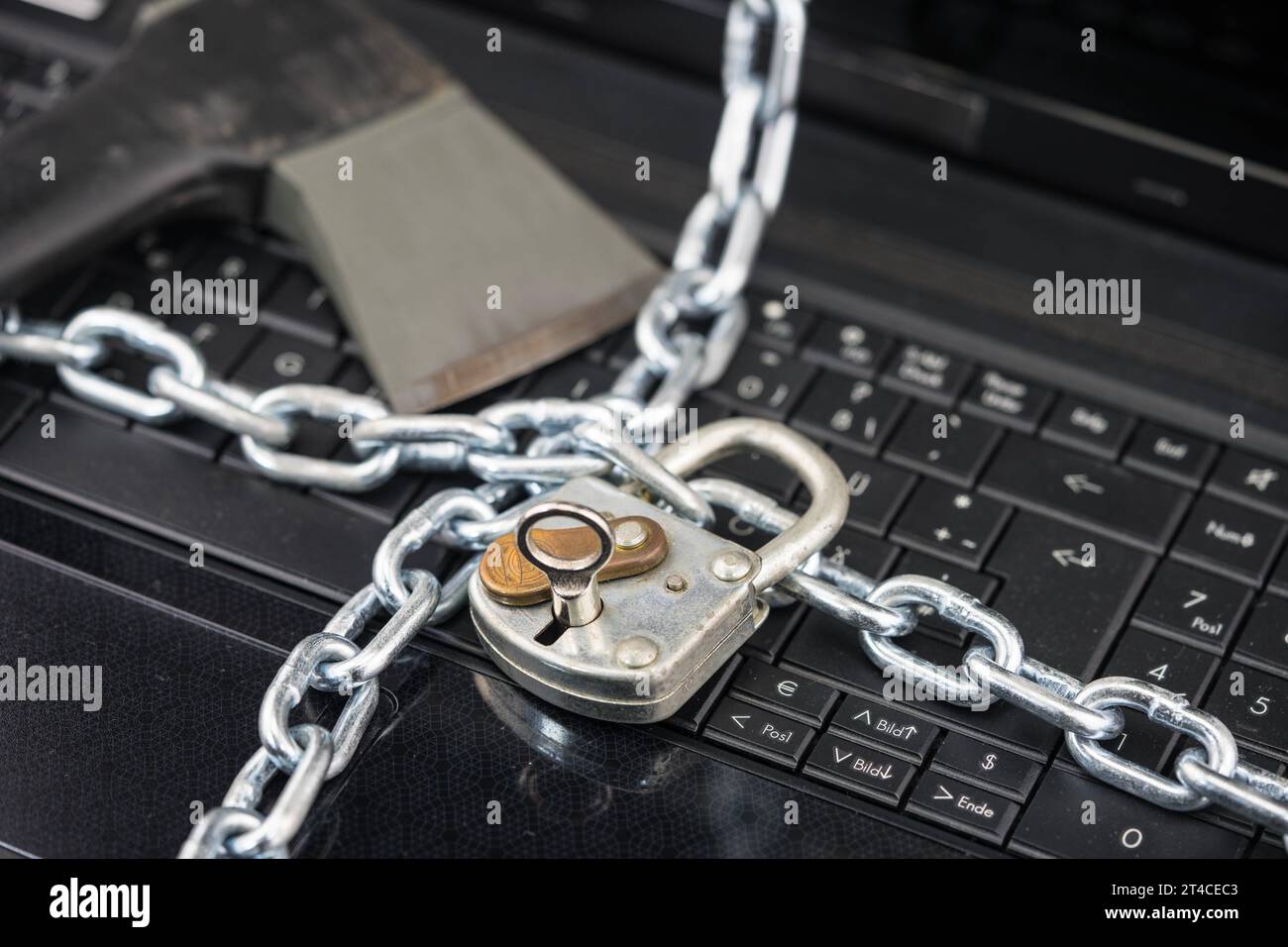 laptop keyboard with chain, safety lock and Ax, data safety Stock Photo ...