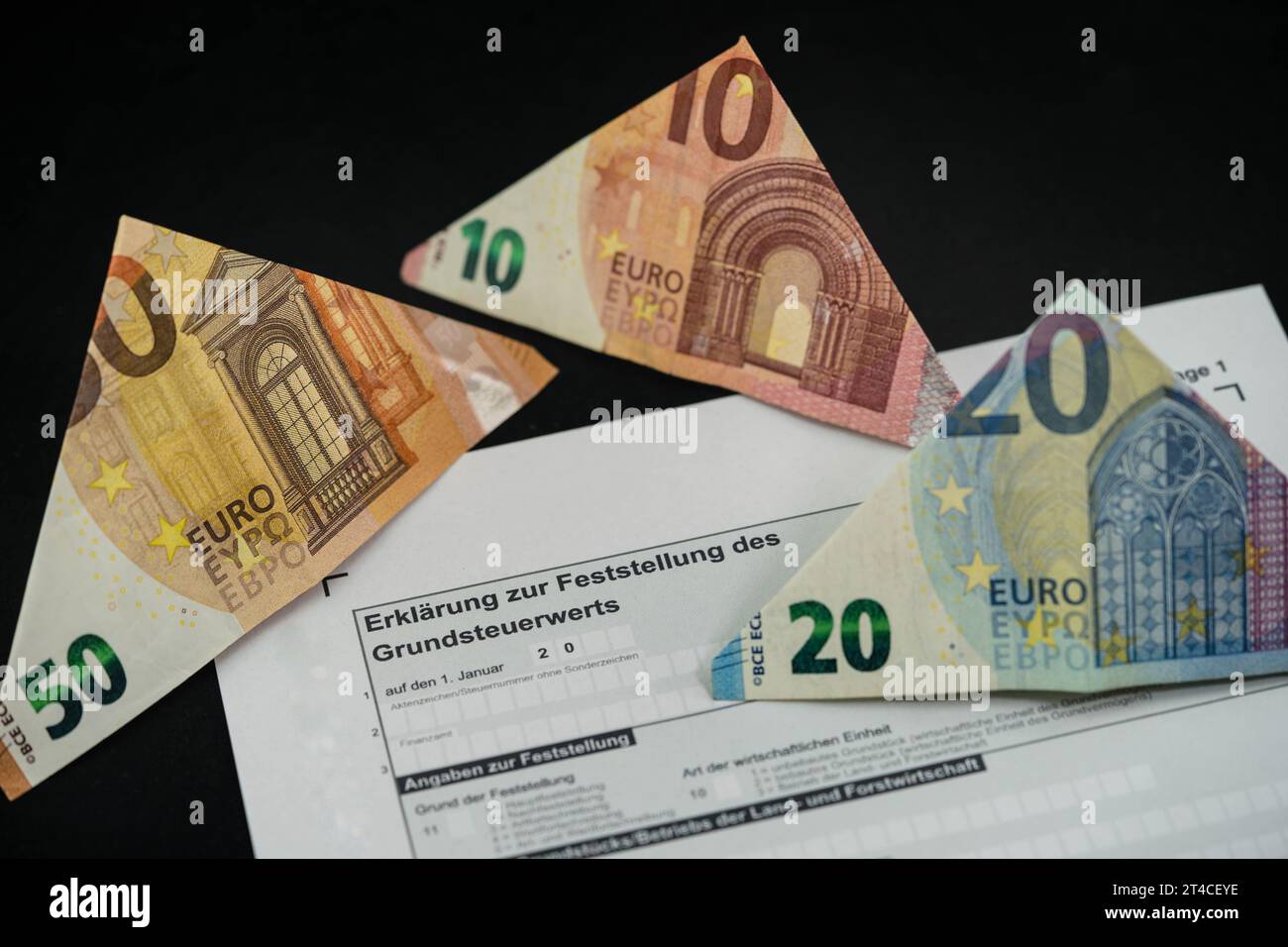 document about land tax with folded Euro bills Stock Photo - Alamy