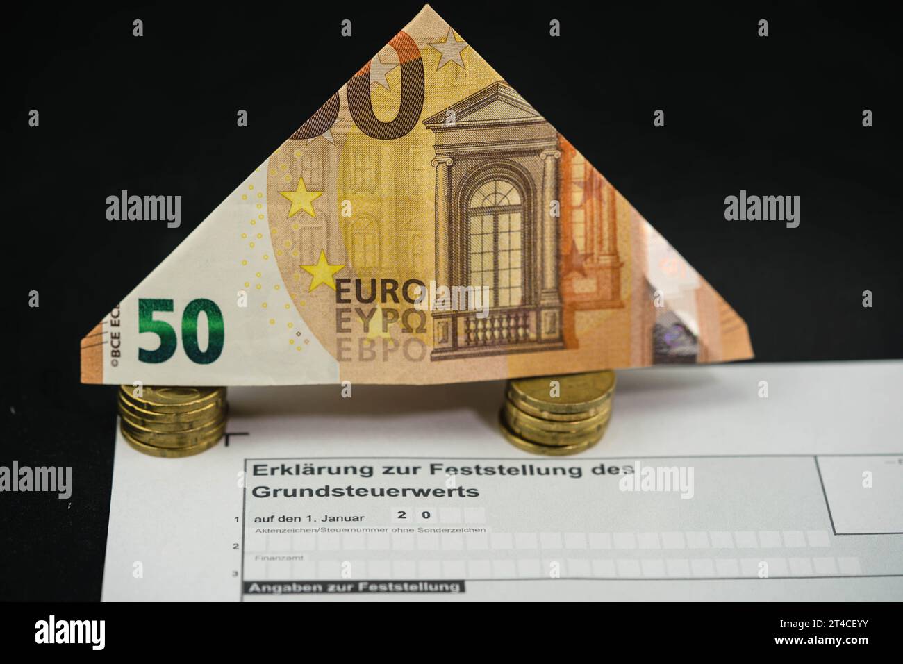 document about land tax with folded 50 Euro bill Stock Photo - Alamy