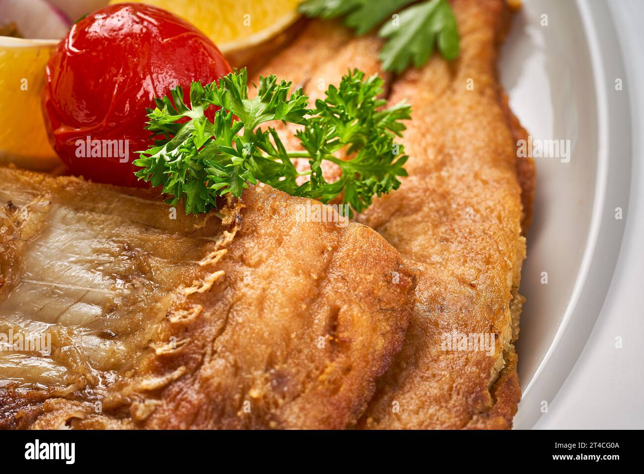 A close-up of A dish of fried fish with rice and vegetables Stock Photo ...