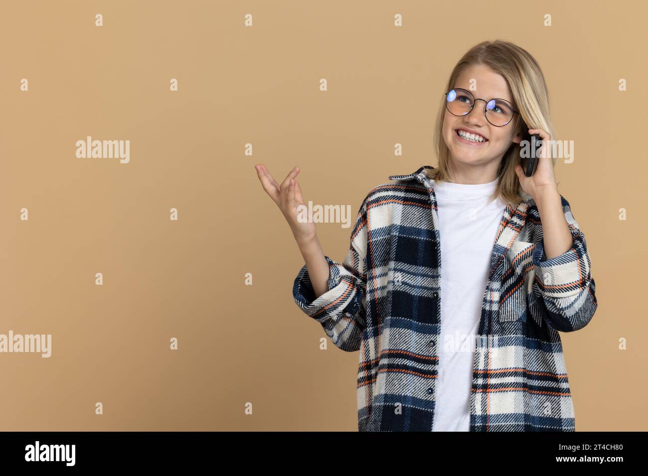 Pretty blonde teen girl talking on the phone and smiling Stock Photo ...