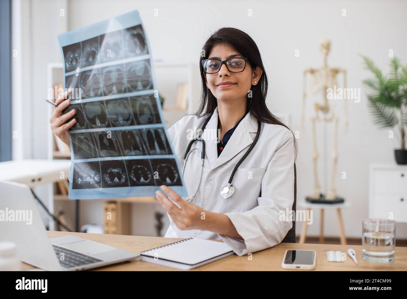 Nurse studying CT brain scans in doctor's office interior Stock Photo ...