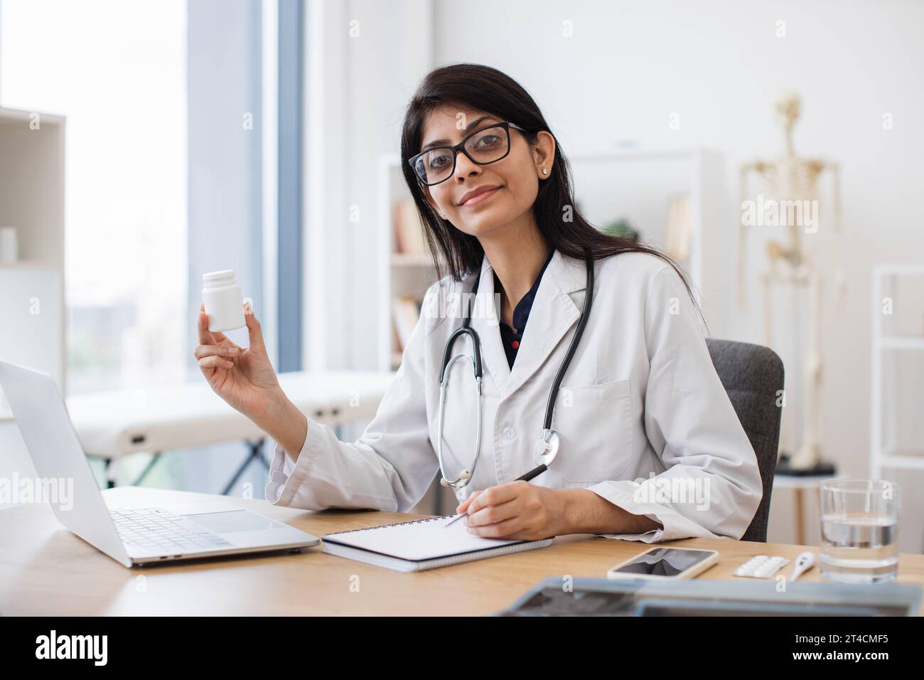 Woman physician using devices and prescribing medication Stock Photo ...