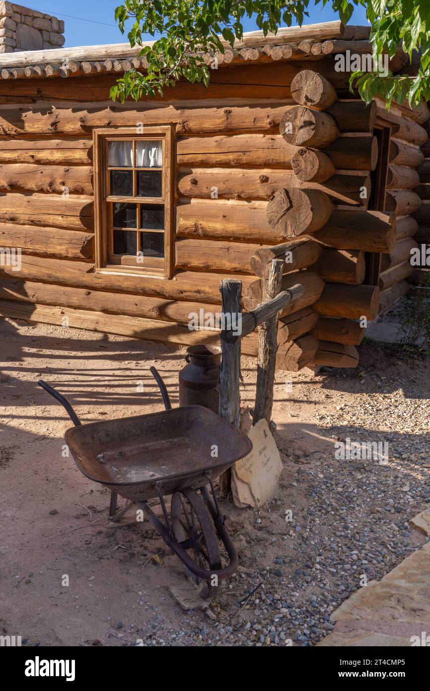 An antique vintage wheelbarrow in front of a log cabin at the Bluff ...