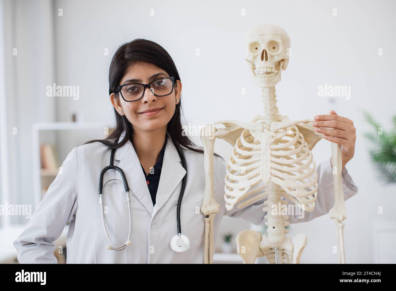 Doctor standing near model of human body in private clinic Stock Photo ...