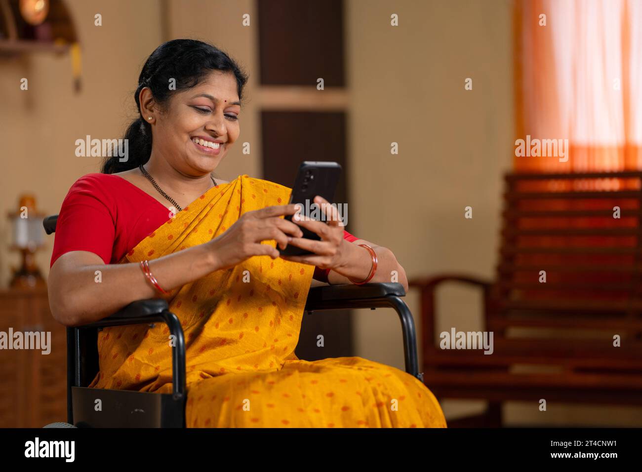 Happy Indian Middle aged recovered sick woman on wheelchair using ...