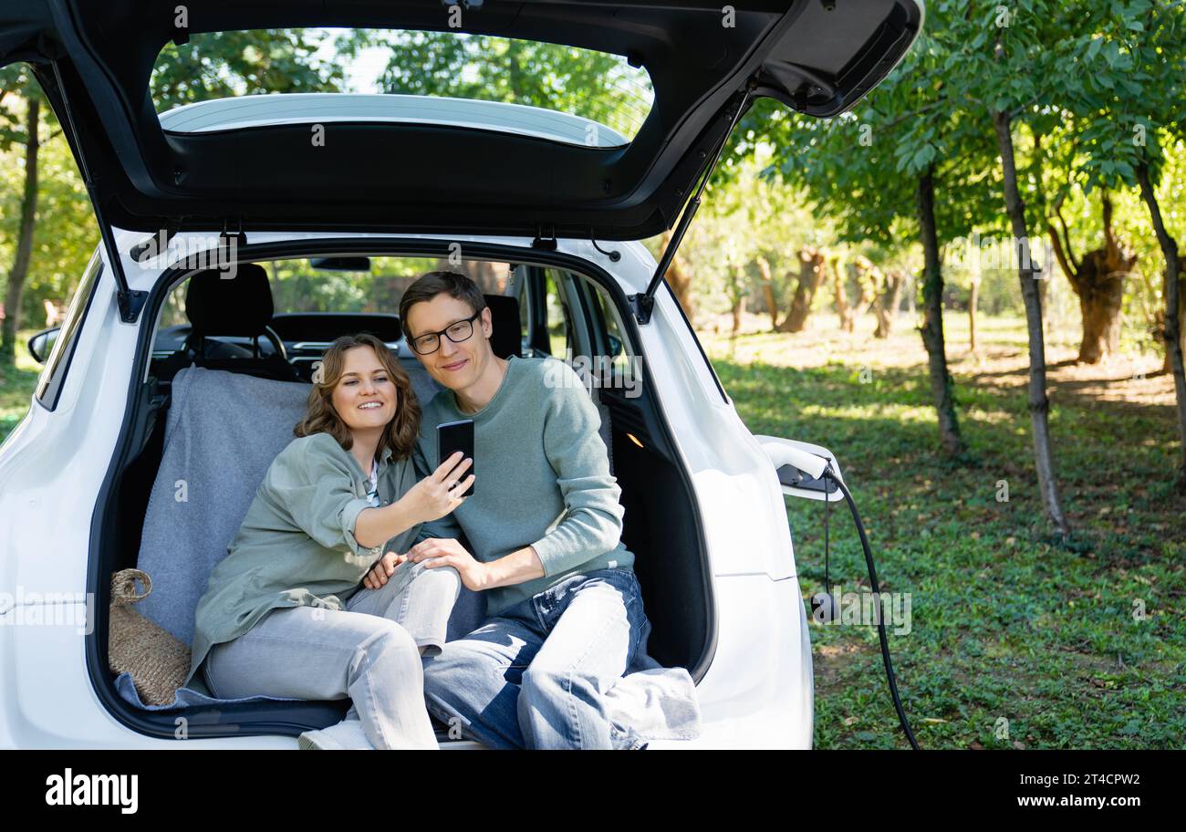Couple electric car charging hi-res stock photography and images - Alamy
