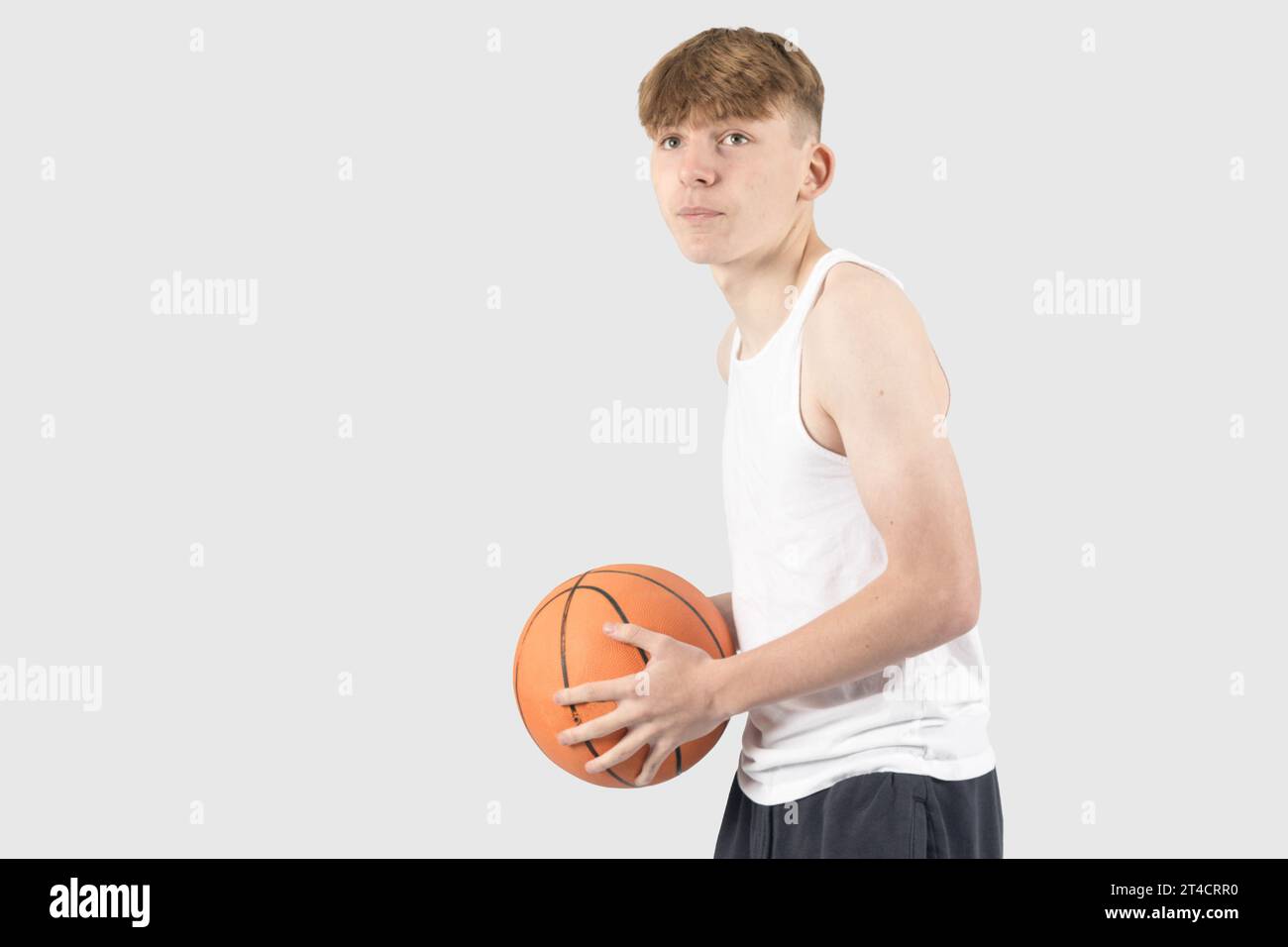 Caucasian teenage boy playing basketball Stock Photo - Alamy