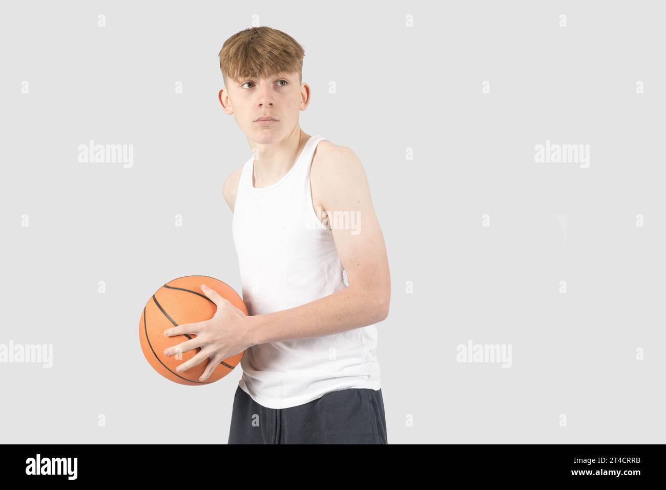 Caucasian teenage boy playing basketball Stock Photo - Alamy