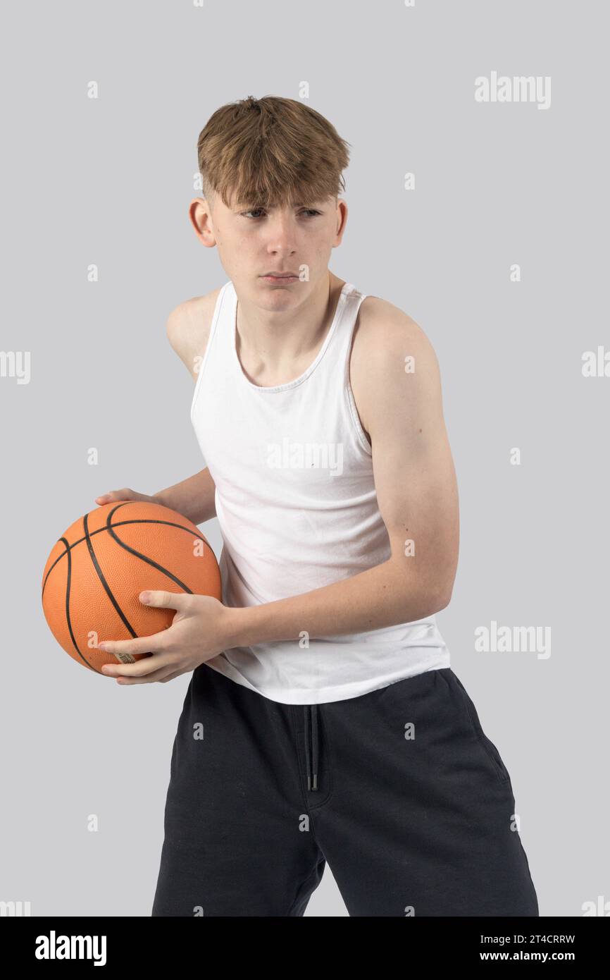 Caucasian teenage boy playing basketball Stock Photo - Alamy