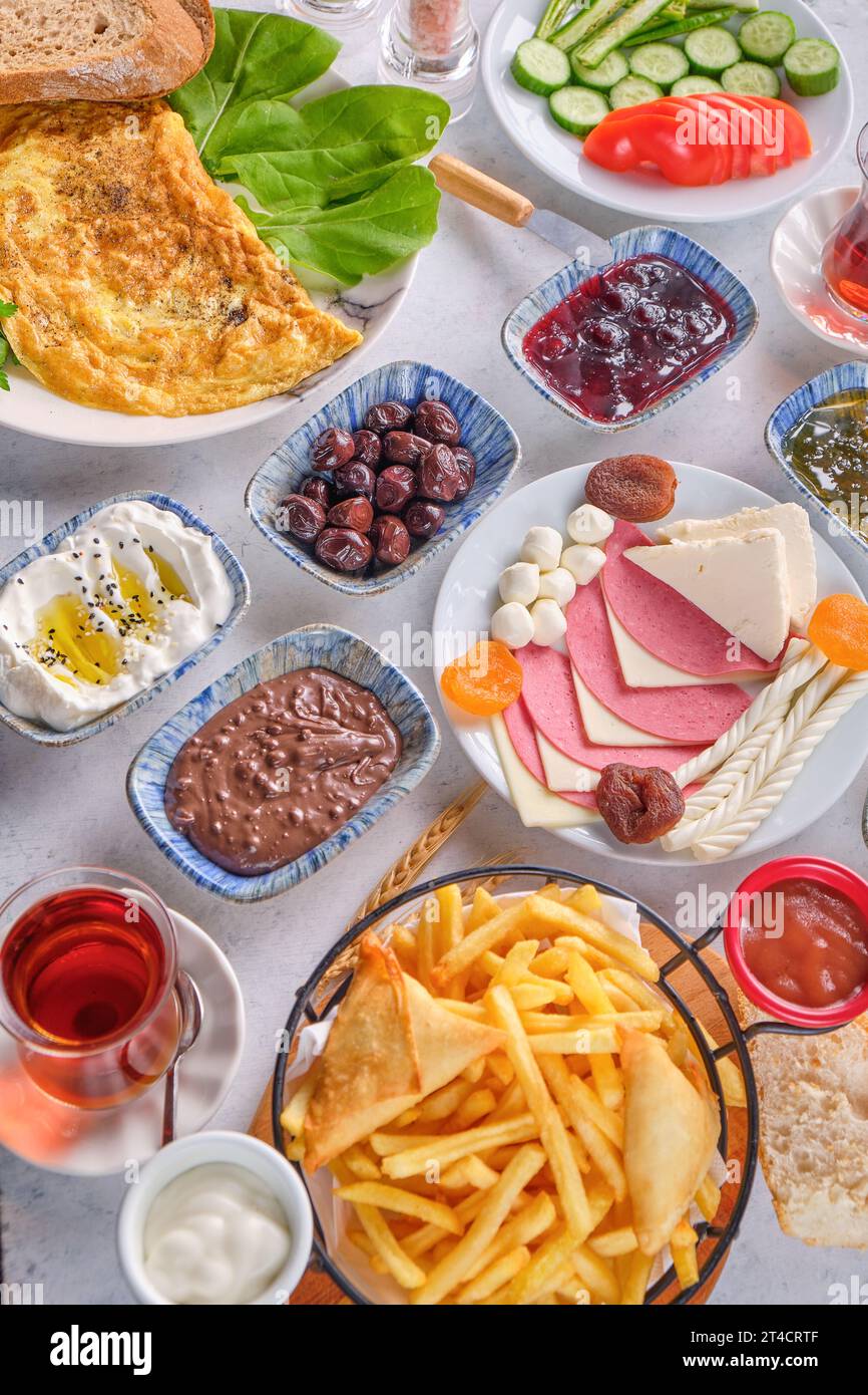 A traditional Turkish breakfast consisting of several dishes, including ...