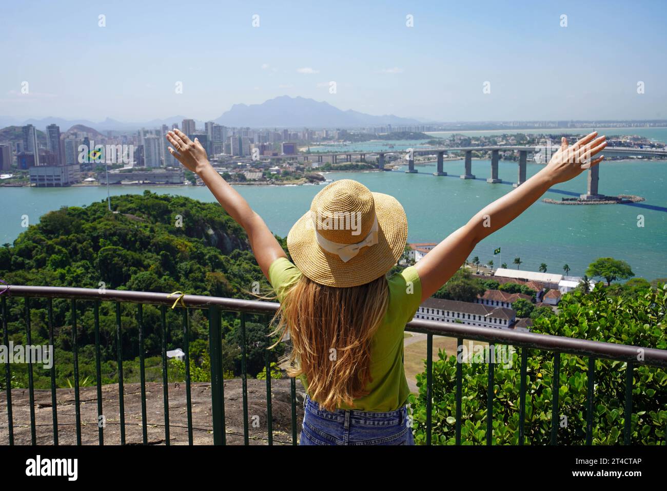 Joyful girl visiting Brazil. Beautiful young woman with raised arms ...