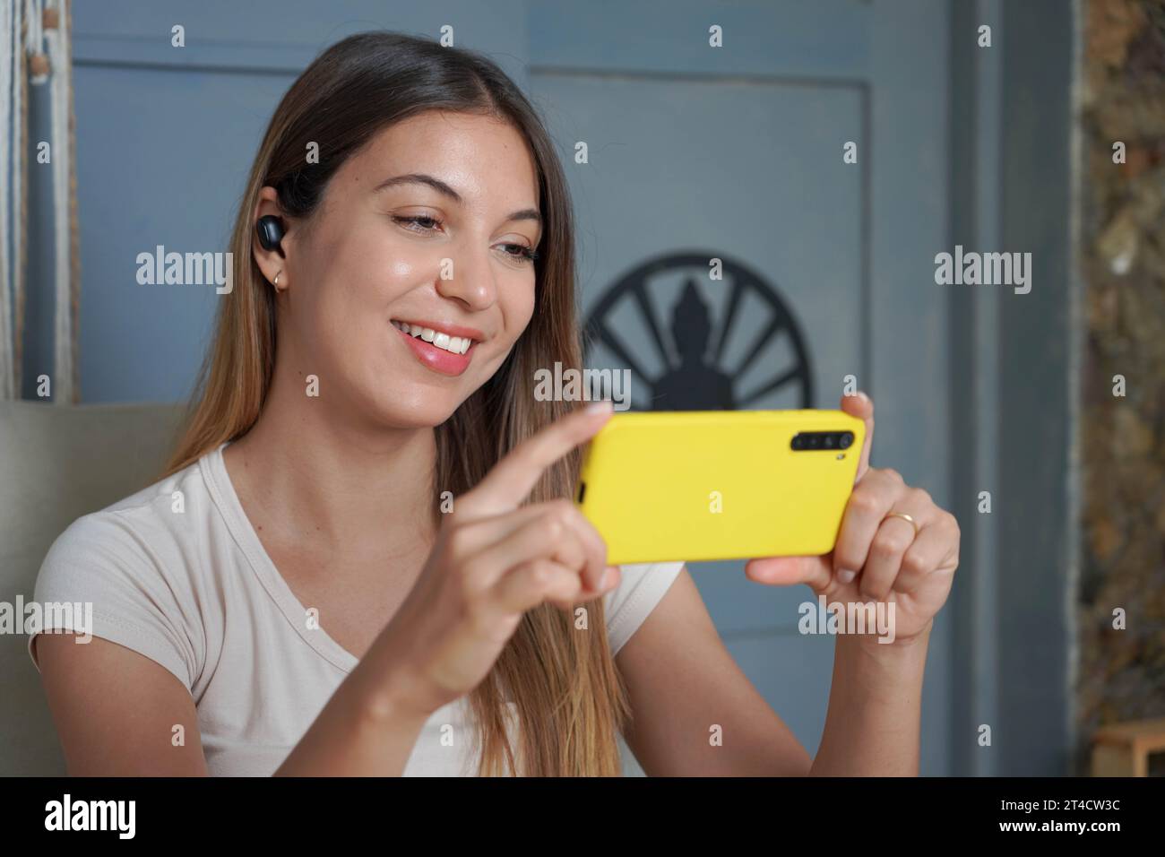 Brazilian Girl With Earbuds Watching Broadcasting On Video Sharing