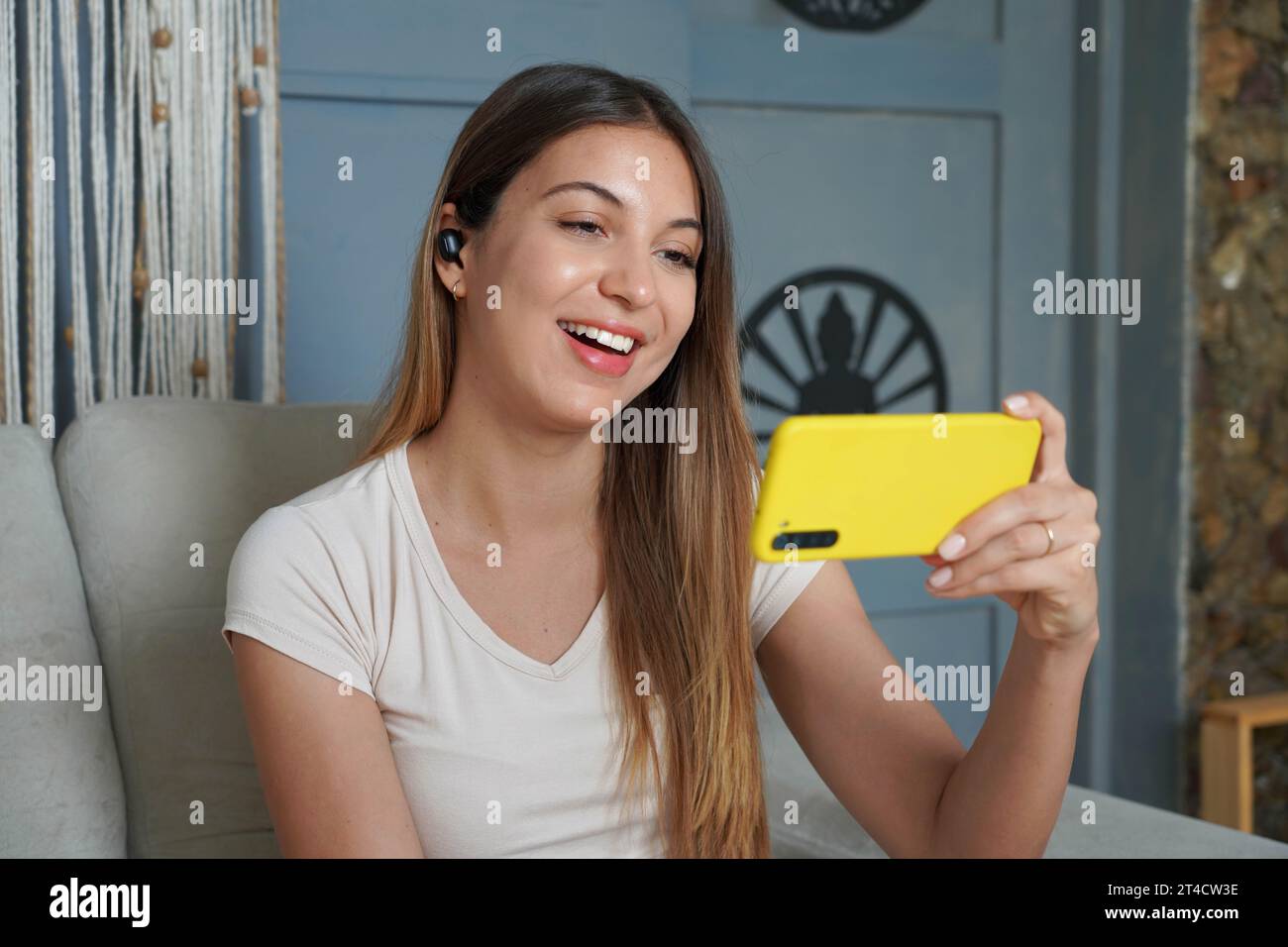 Brazilian woman watching broadcasting on video sharing platform sitting ...