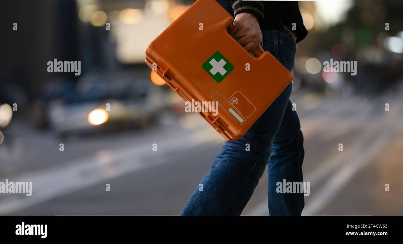 Man with first aid kit is running to help Stock Photo - Alamy