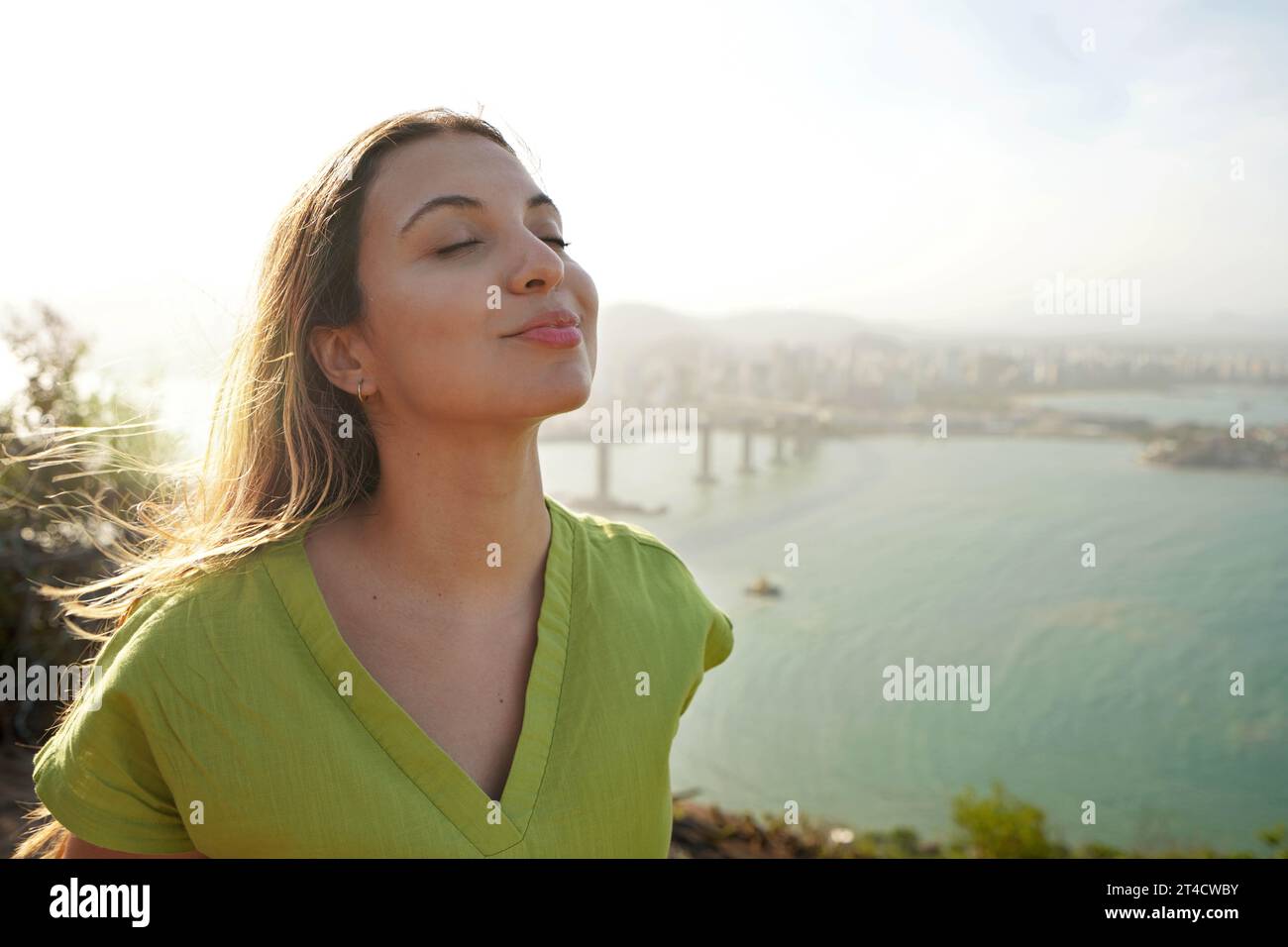 Happy traveler woman enjoying relaxed wind on face at sunset in her ...