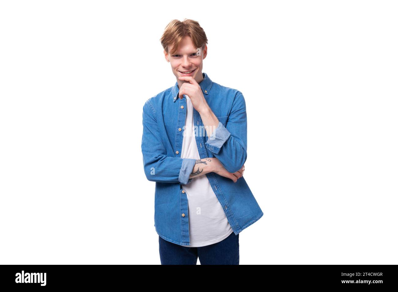 portrait of a smiling caucasian red-haired guy in a denim blue denim ...