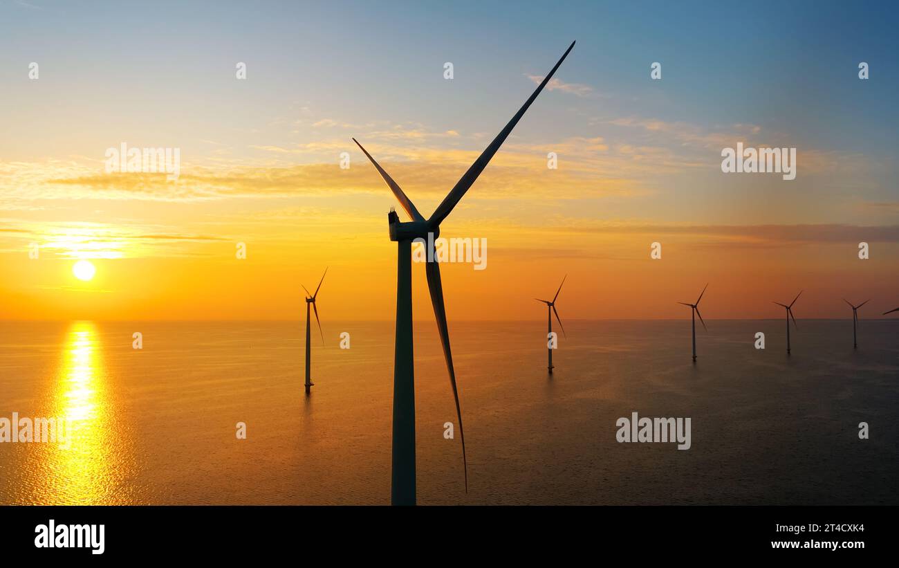 Working offshore wind farm at sunset. Aerial view of wind turbines ...