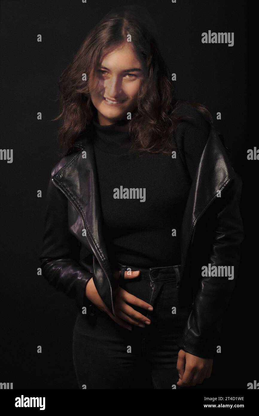 Beautiful brunette teenage girl wearing a black leather jacket: low ...