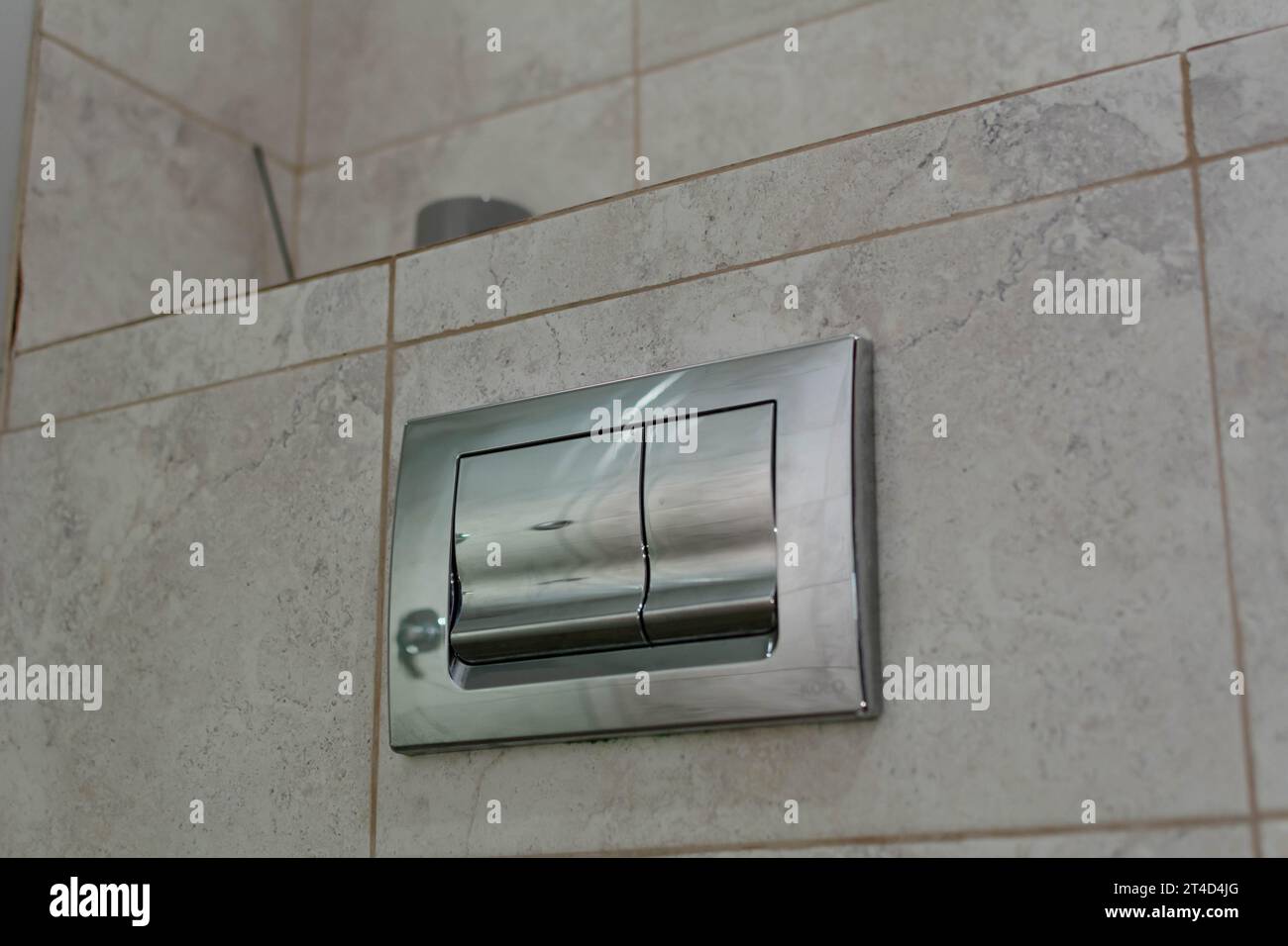 Modern Dual button for flushing in the hotel bathroom. Selective focus ...