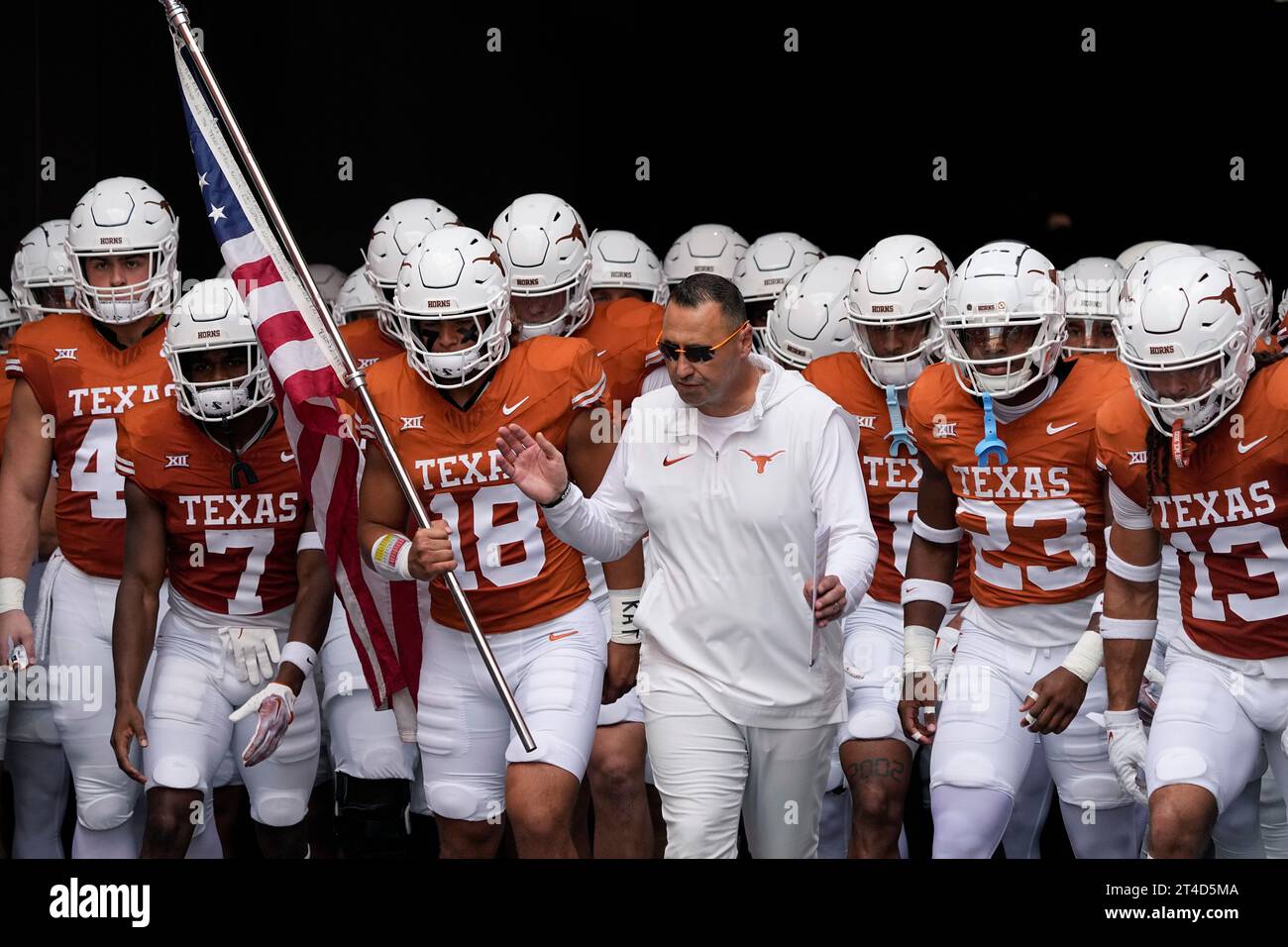 Texas head coach Steve Sarkisian, center, leads his team on to the ...