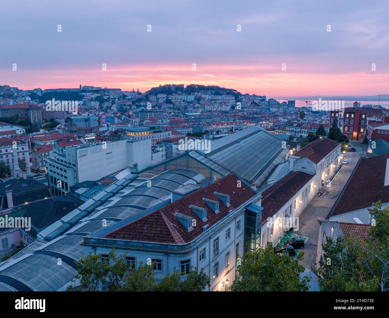 A aerial cityscape of Lisbon, taken at sunrise from the Miradouro de ...